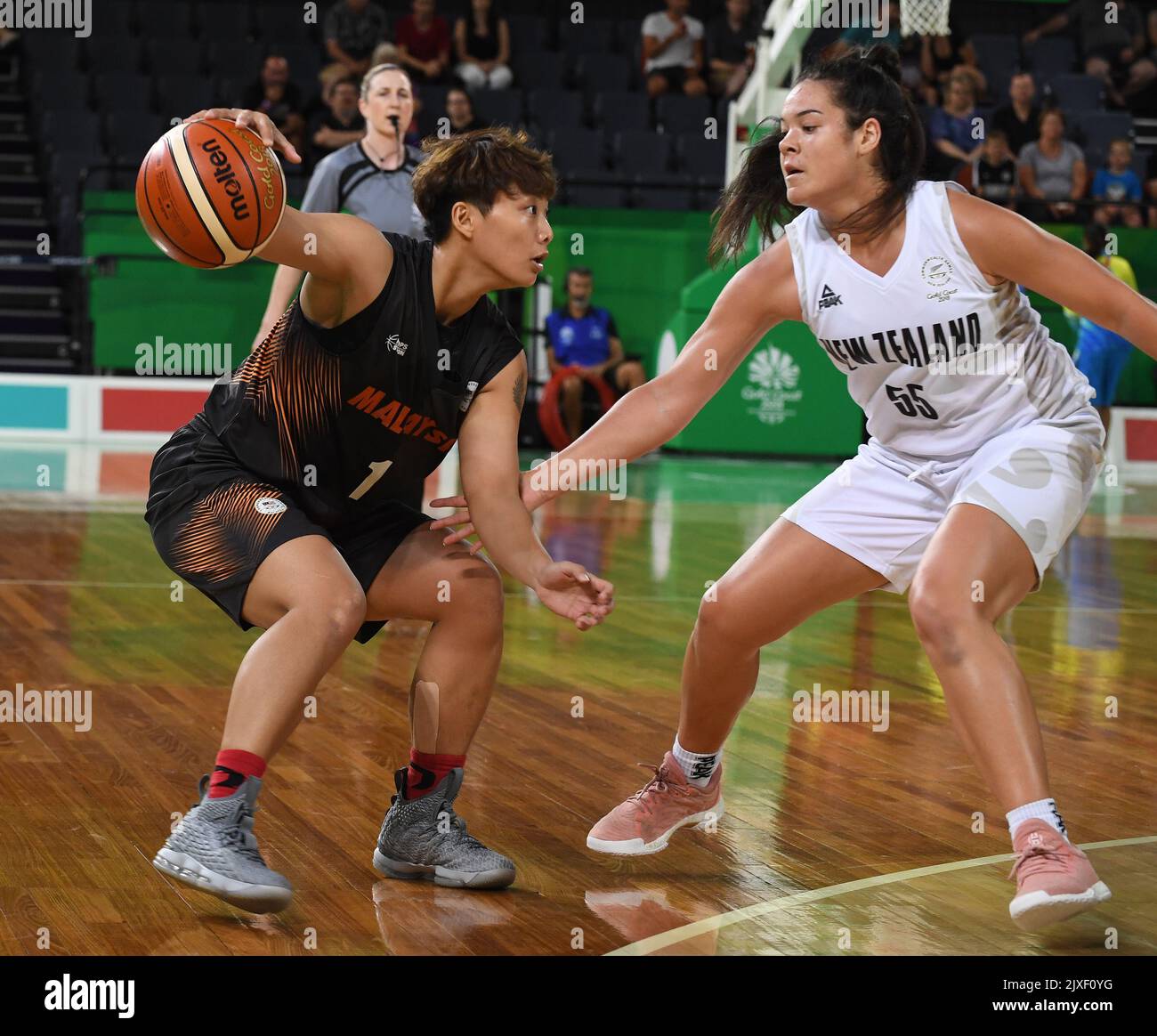 Malaysia's Hui Pin Pang is confronted by New Zealands Chalisse Leger ...