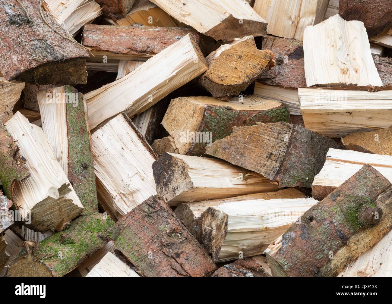 Pile of split logs Stock Photo - Alamy