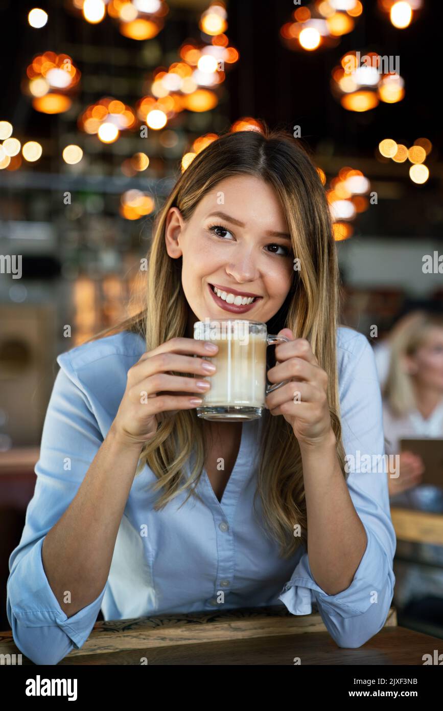 Portrait of happy young business woman drinking coffee in a break Stock ...