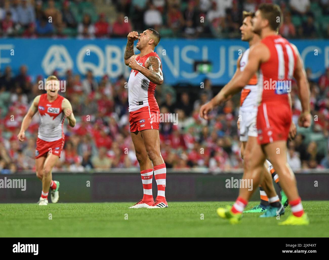 Lance Franklin of the Swans (centre) celebrates scoring his second goal ...
