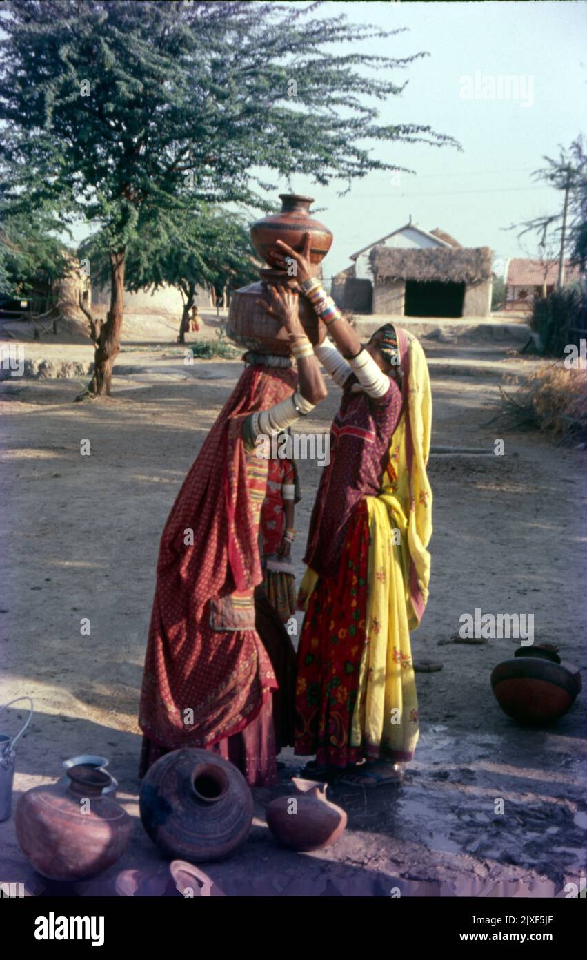 Helping to put pot on head hi-res stock photography and images - Alamy