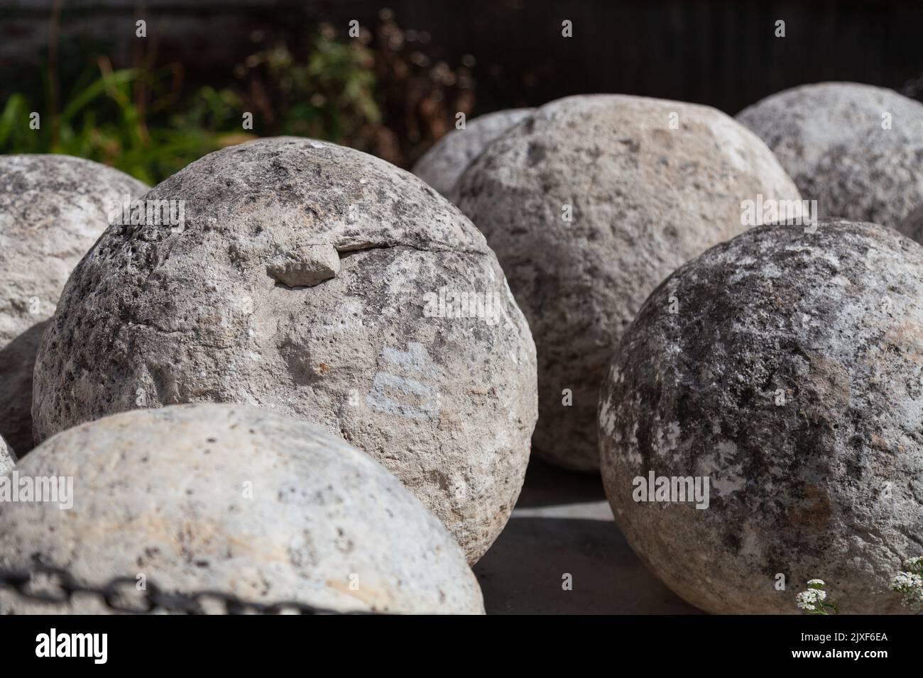 Large vintage stone cannon balls on a blurred background Stock Photo ...