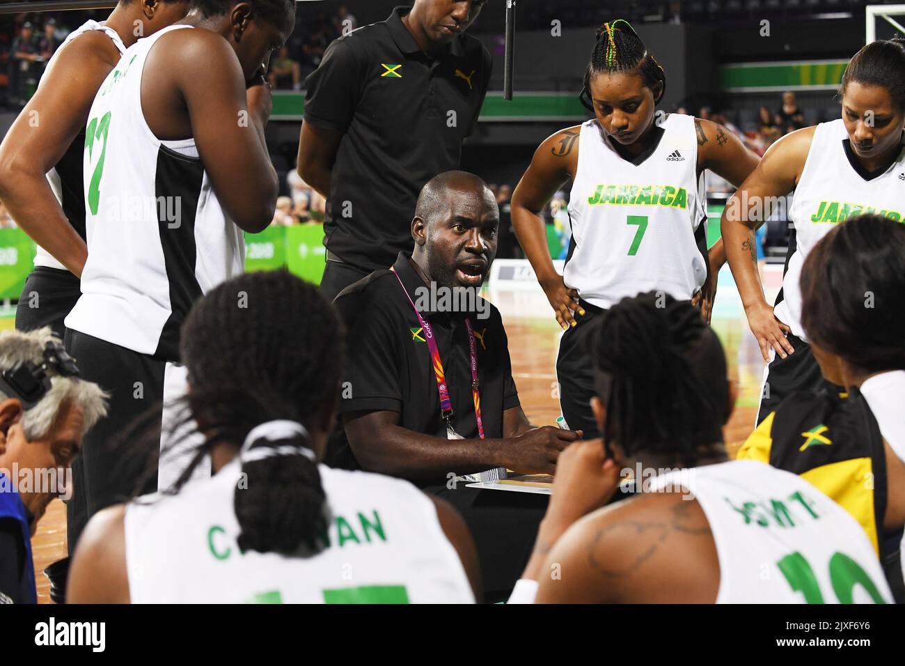 Jamaican coach Rohan Robinson speaks to his team during a timeout ...