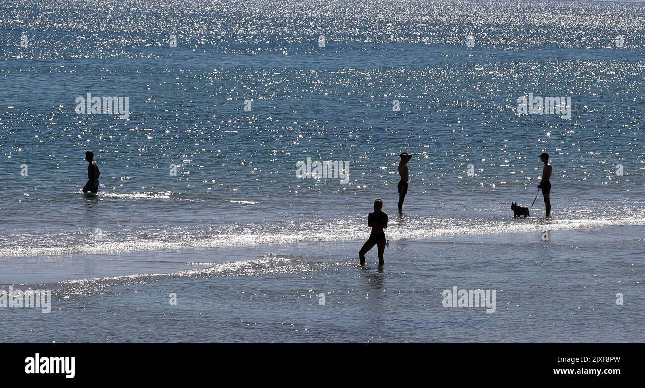 People are seen enjoying the hot weather on Henley Beach in Adelaide ...