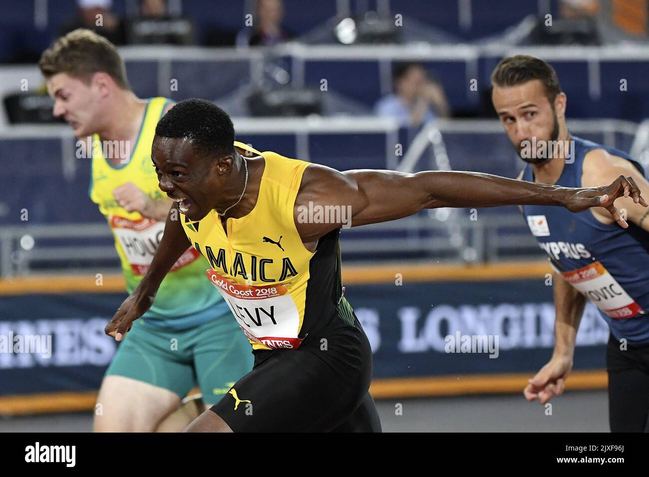 Ronald Levy of Jamaica (second left) crosses the finish line to win the ...