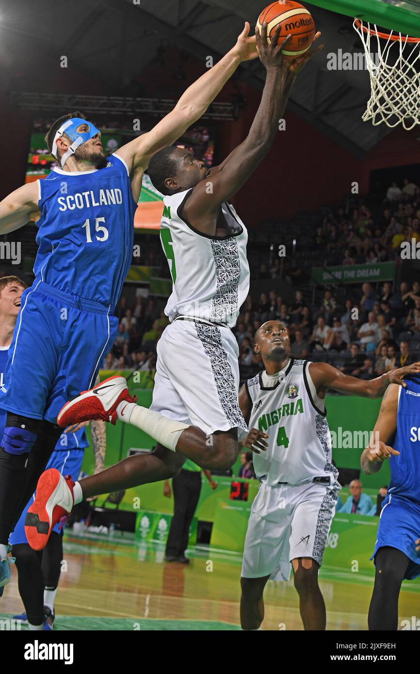 Nigeria's Musa Usman goes up to shoot as Scotland's Alasdair Fraser ...