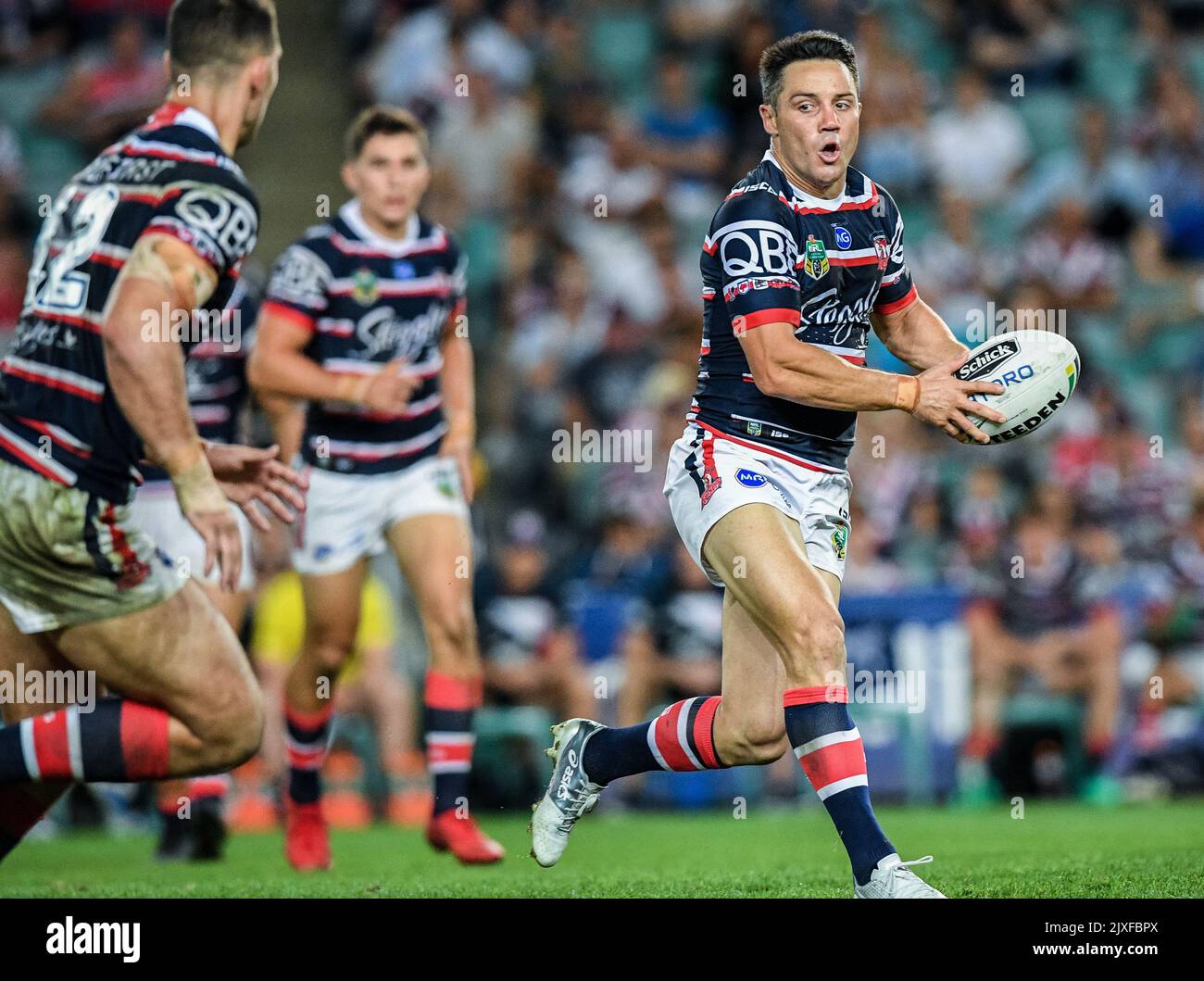 Cooper Cronk (right) of the Roosters runs with the ball during the ...