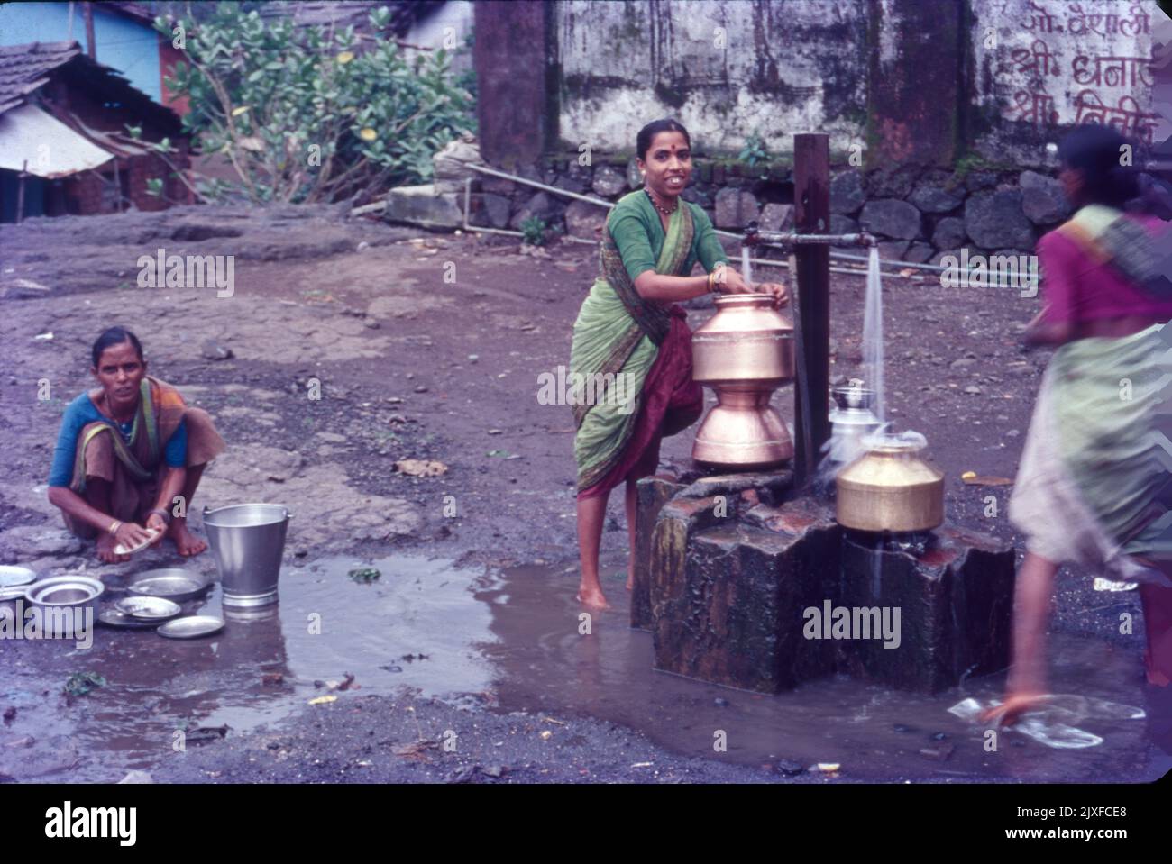 Village women, Filling water and Cleaning Stock Photo - Alamy