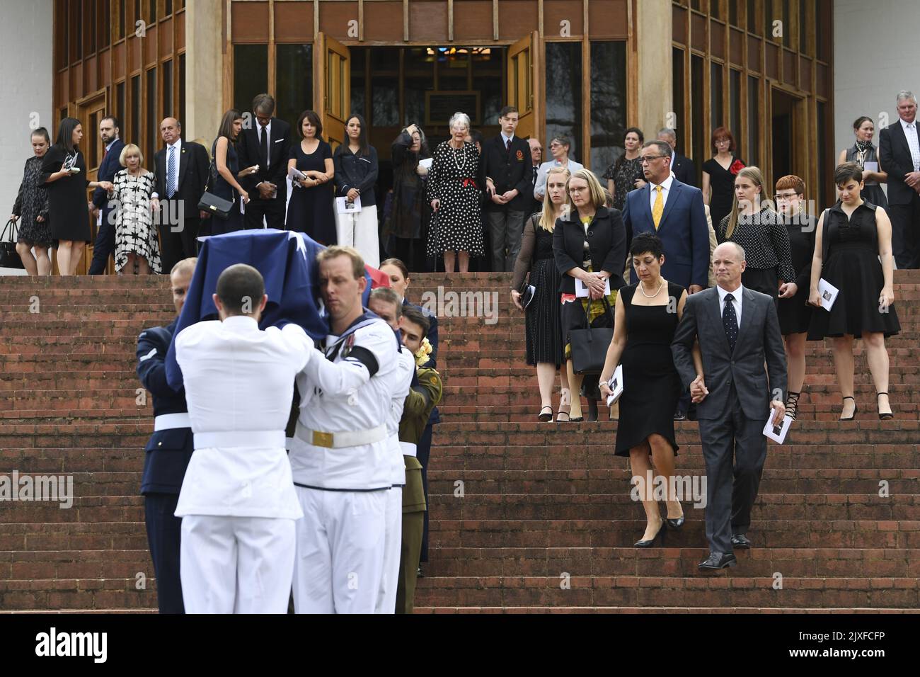 Former Queensland Premier Campbell Newman and his wife Lisa walk behind ...