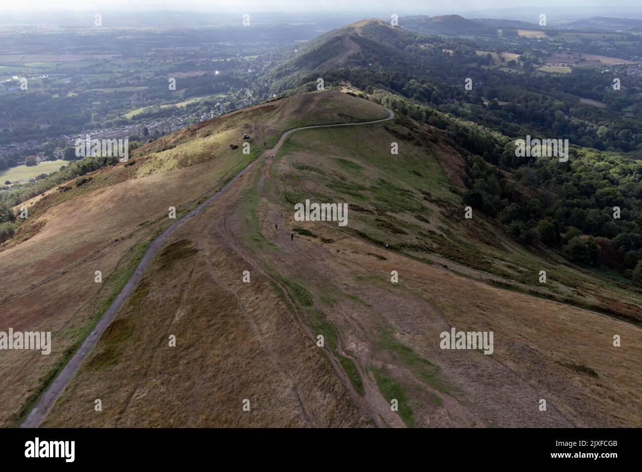 People walk along the Malvern Hills overlooking Great Malvern, in ...