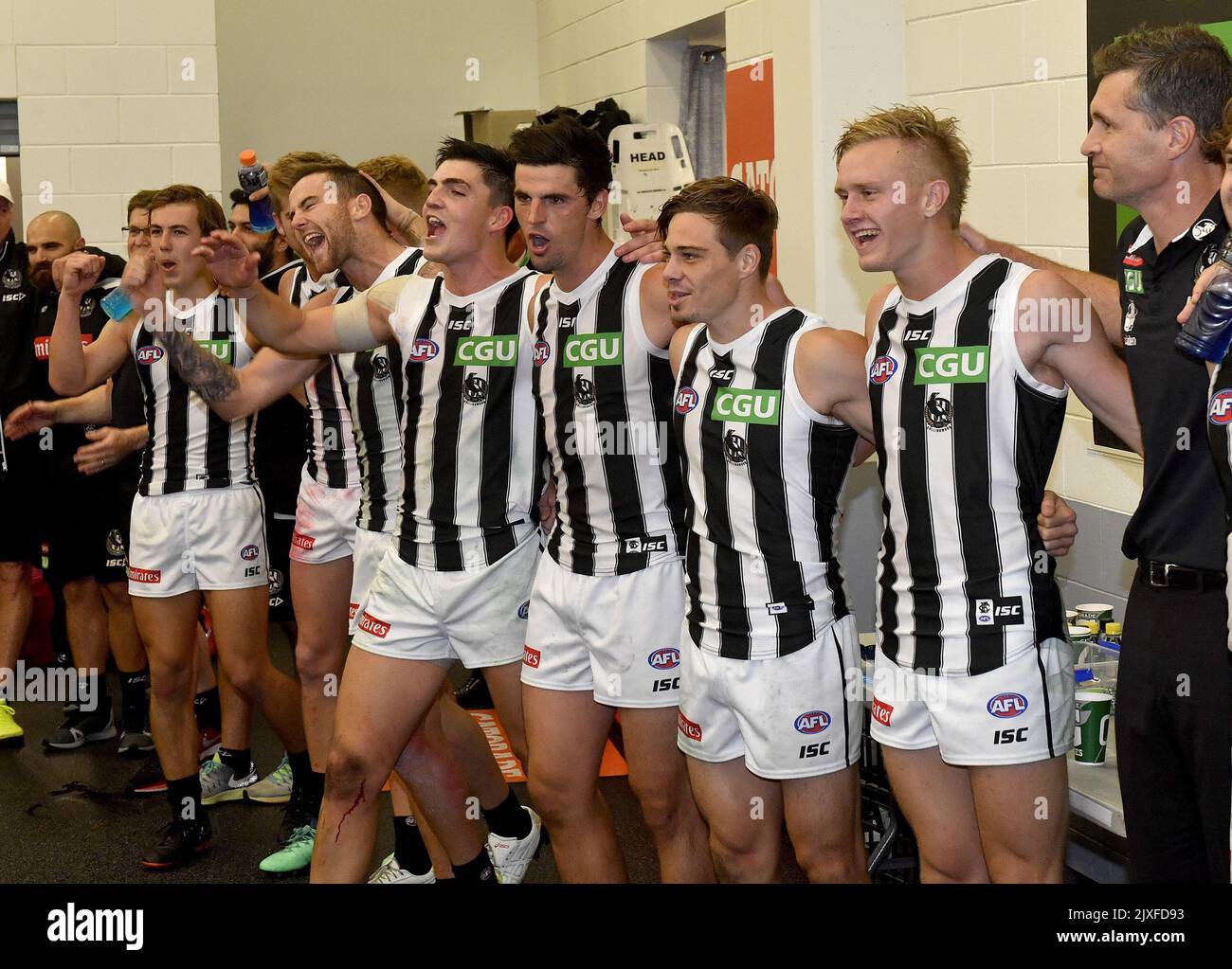Collingwood players sing their club song after the Round 4 AFL match ...