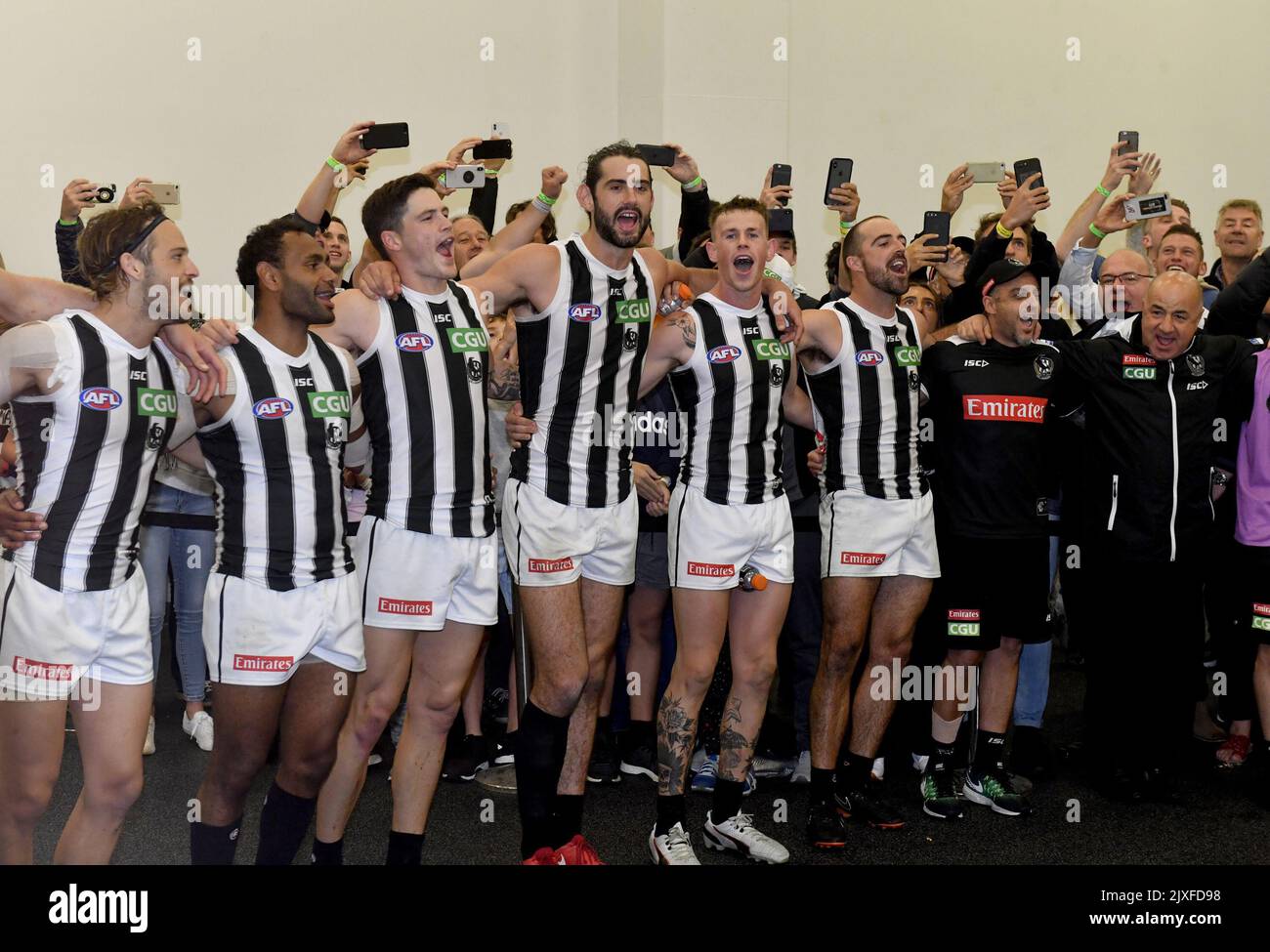 Collingwood players sing their club song after the Round 4 AFL match ...