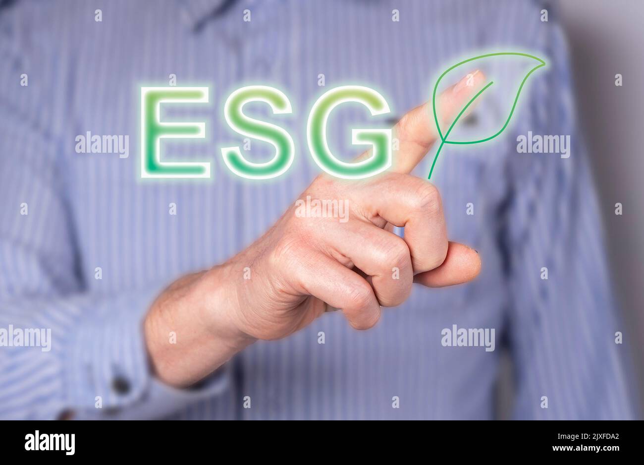 Man hand touching ESG abbreviation with leaf at digital screen. Doing ...