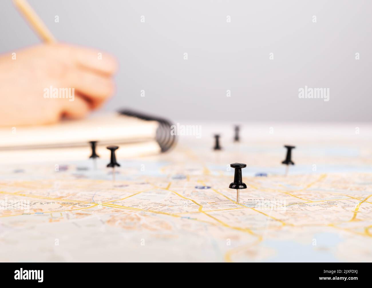 Woman planning travel itinerary. Hand taking notes in planner and ...