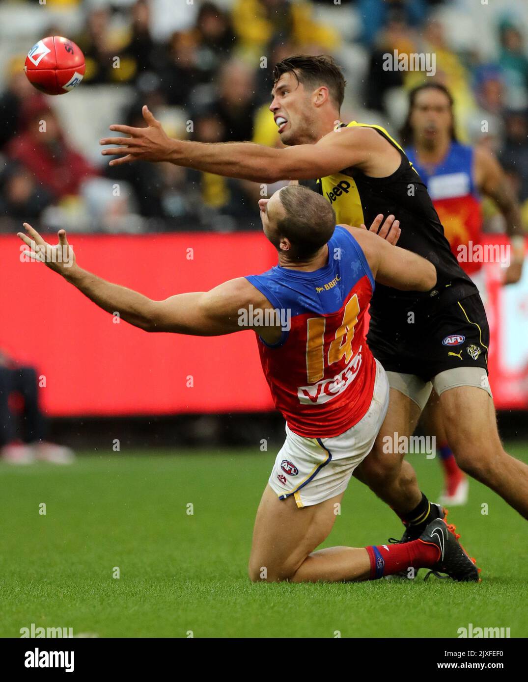 Josh Walker of the Lions competes with Alex Rance of the Tigers during ...