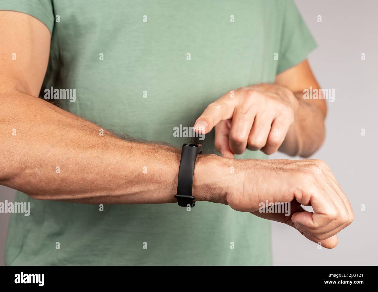Man wearing fitness tracker and checking physical activity results ...