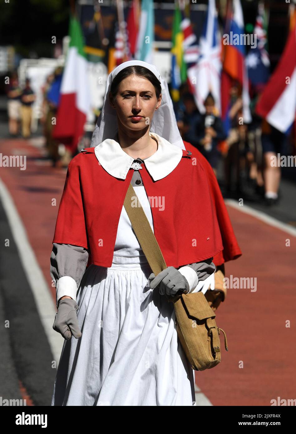 A women dressed as a WWI nurse takes part in an Anzac Day parade in ...