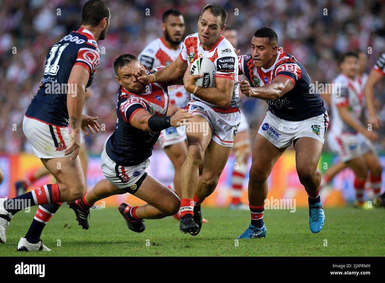 Jason Nightingale of the Dragons is tackled by Jared Waerea-Hargreaves ...