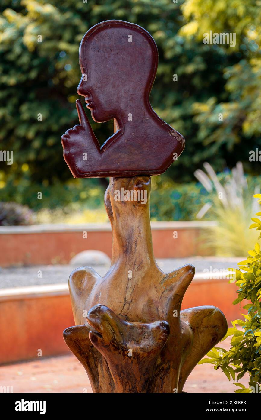 silence symbol wood carved garden object Stock Photo - Alamy