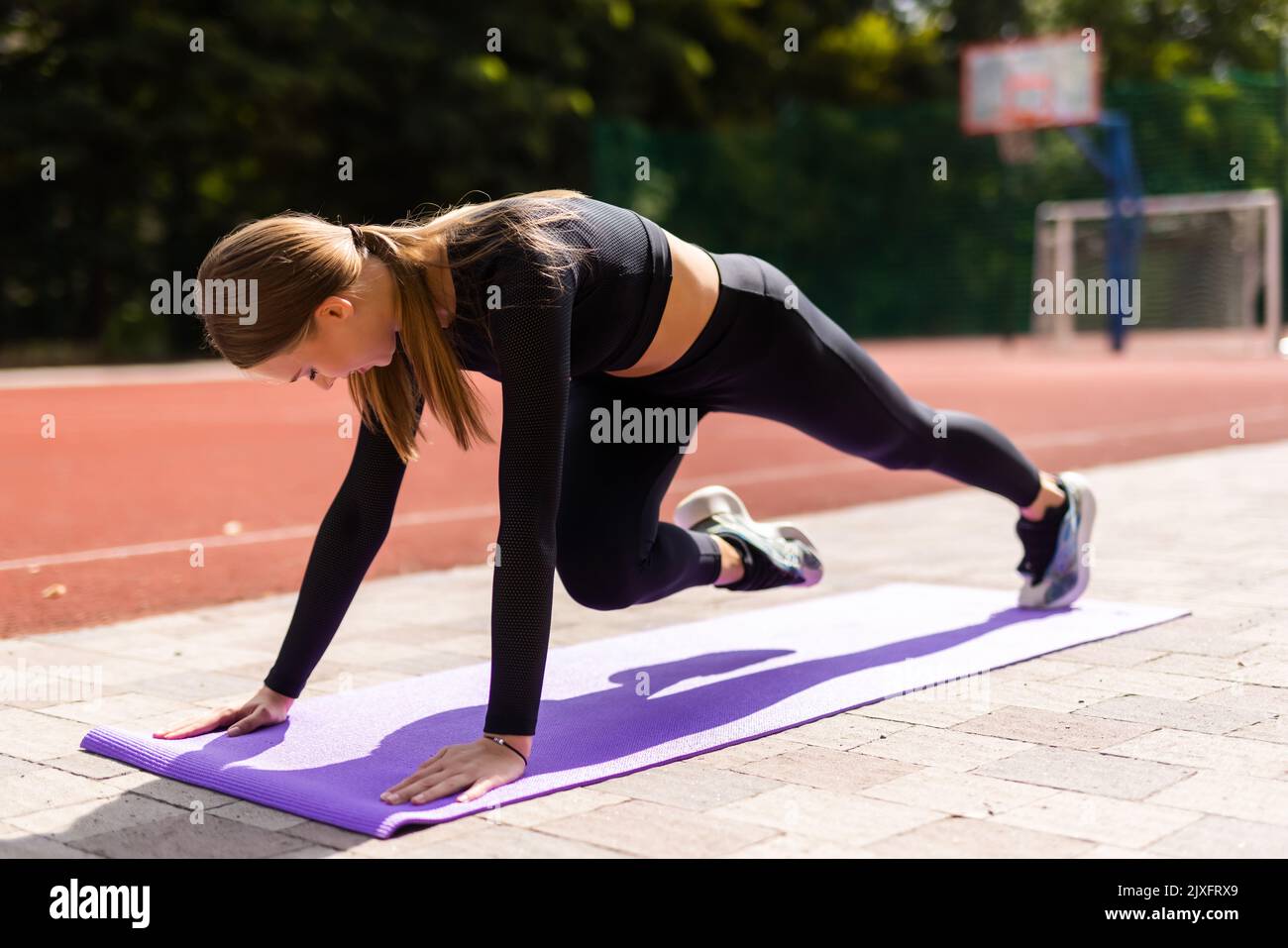 Fitness girl doing abs exercise to tone stomach muscles. Tiger curl ...