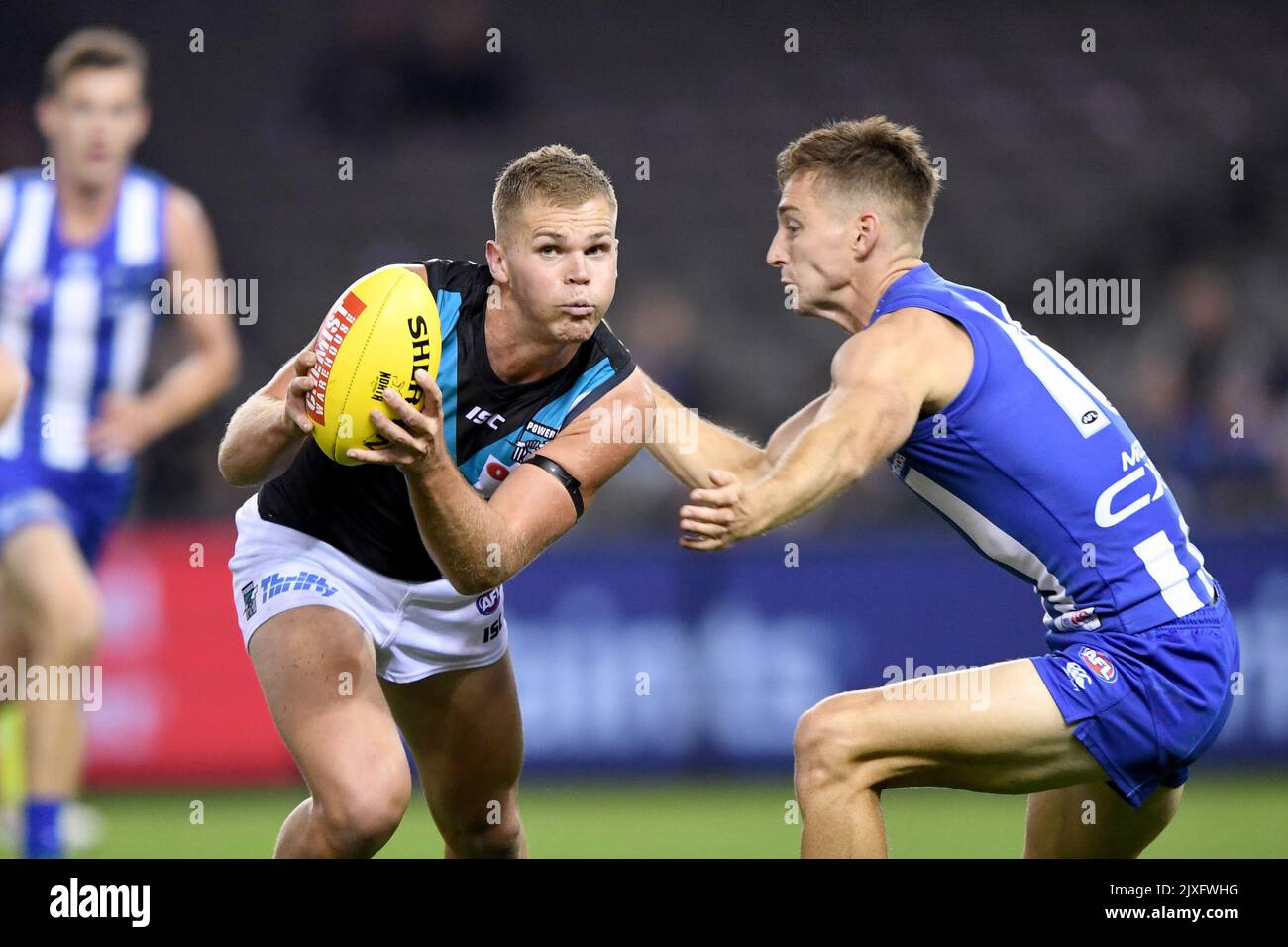 Dan Houston of the Power gets around a tackle by Shaun Atley of the ...
