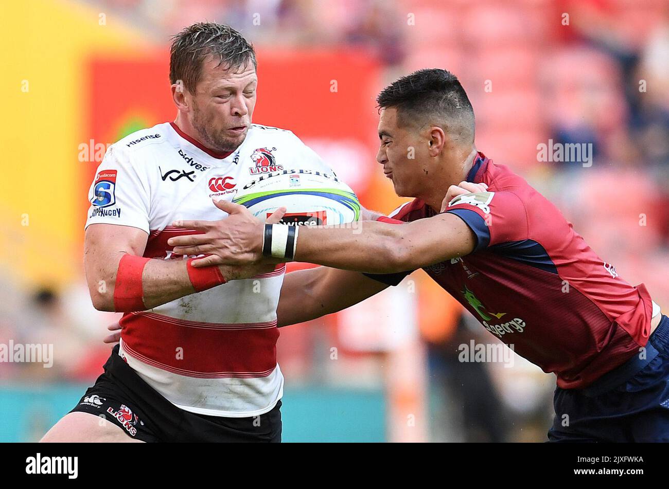 Ruan Combrinck of the Lions (left) is tackled by Jordan Petaia of the ...