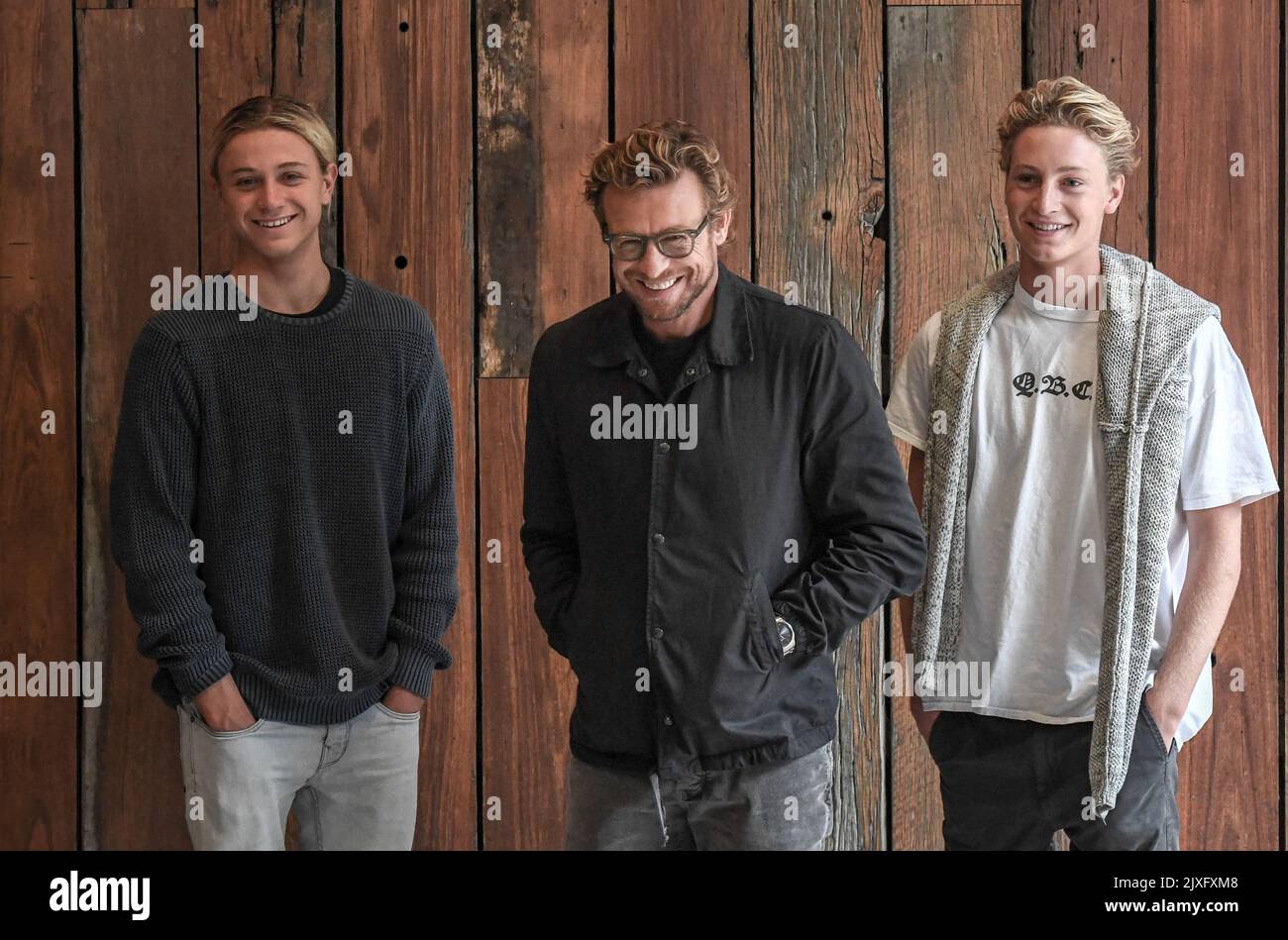 Simon Baker (centre) poses for photos with fellow cast members (left ...