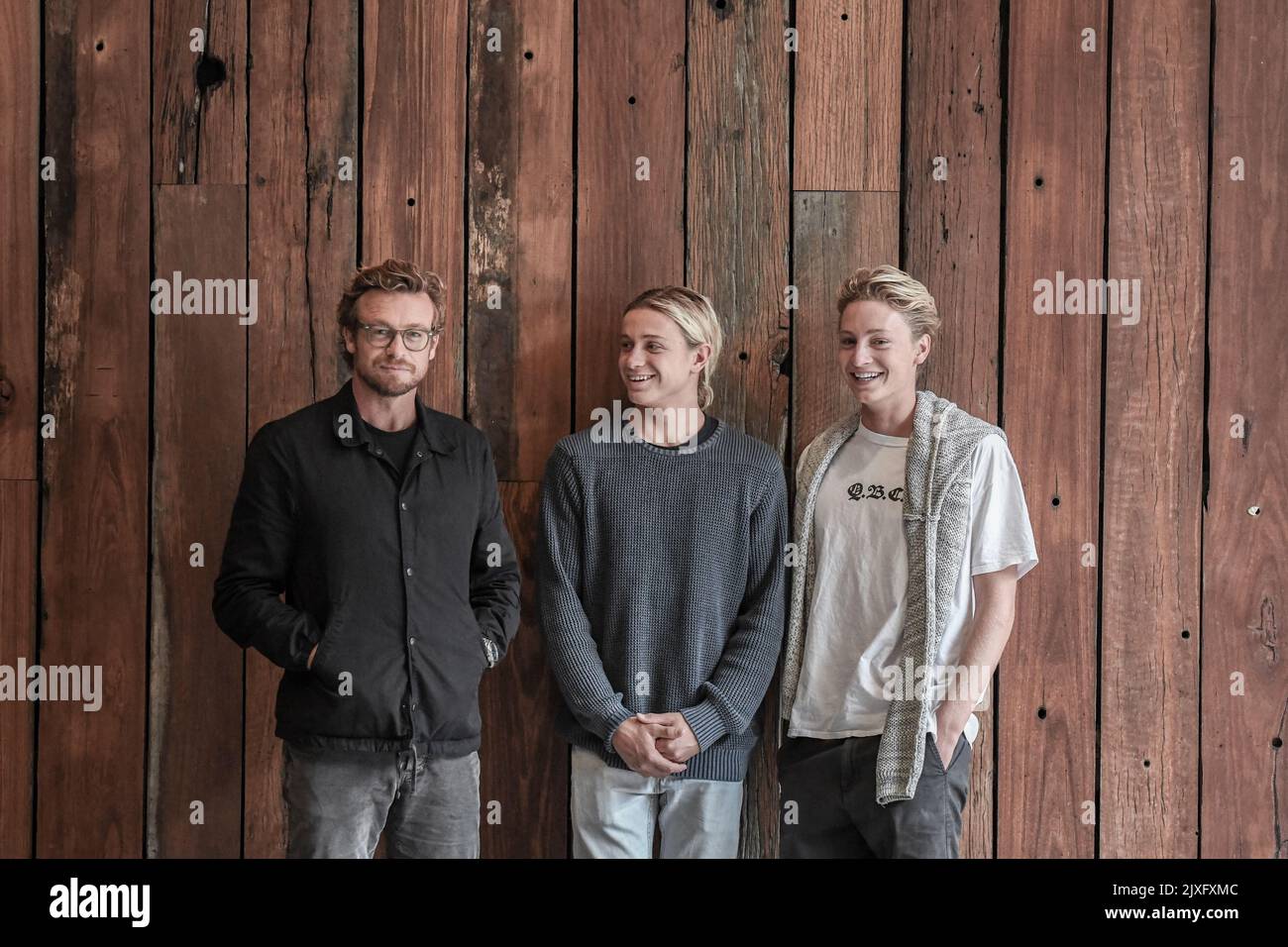 Simon Baker (left) poses for photos with fellow cast members Ben Spence ...