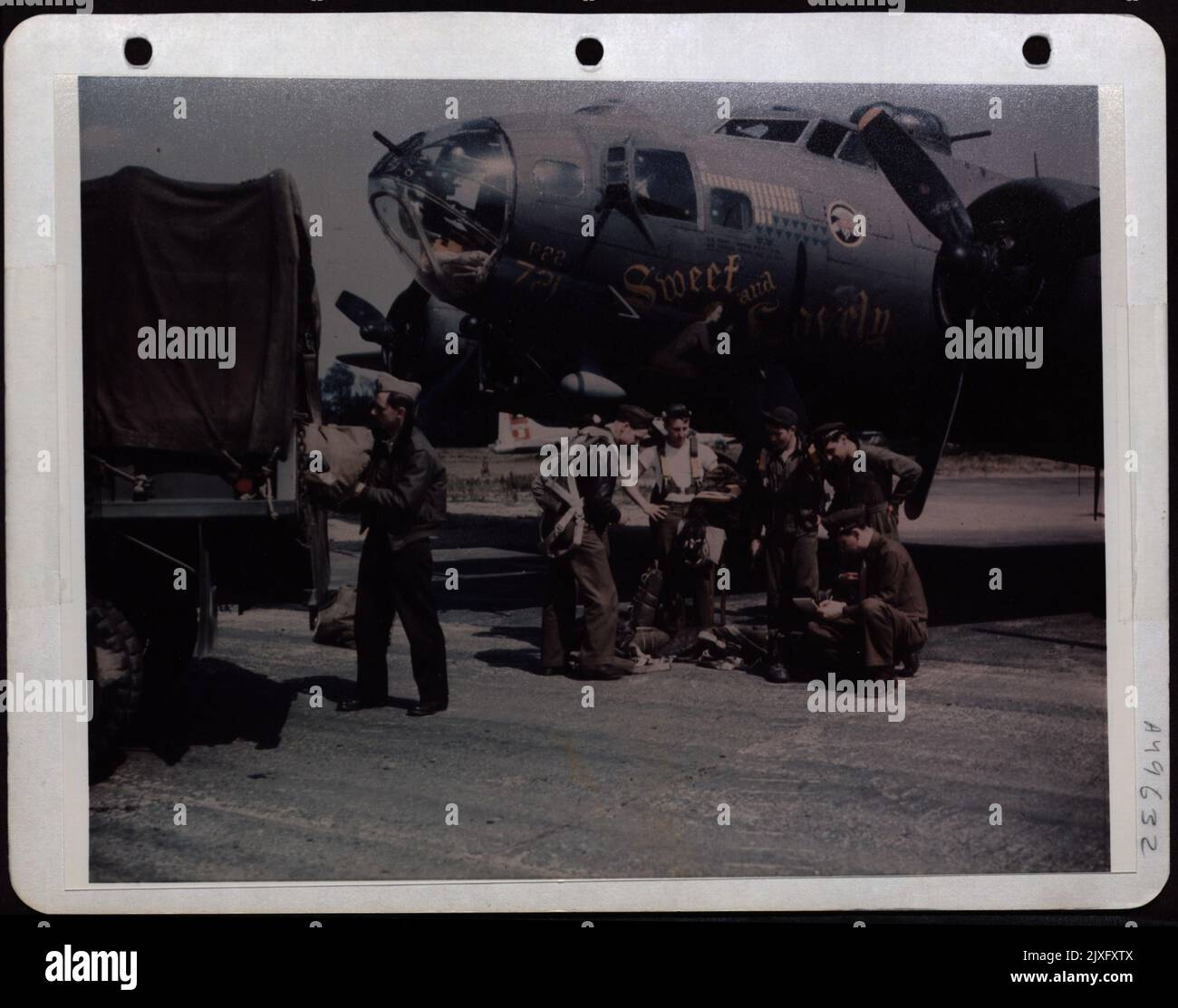 An Air Force Navigator On B-17 'Sweet And Lovely' Tosses Flight Bag On ...