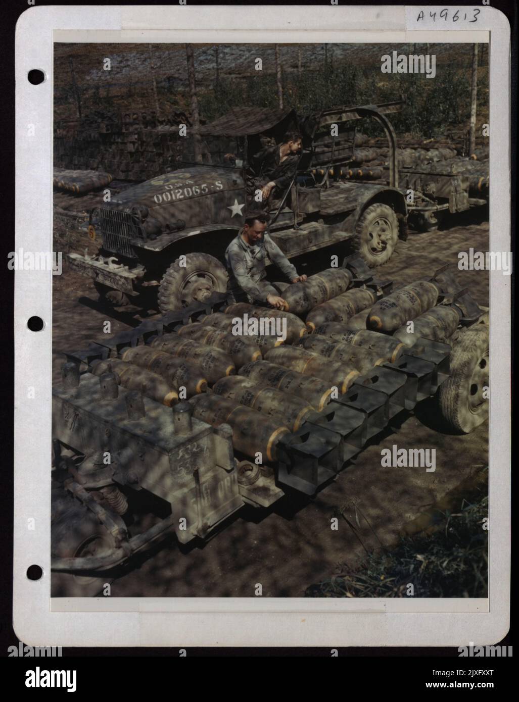 Armament Men Load Bombs On A Trailer As A Man Backs A Truck To An ...
