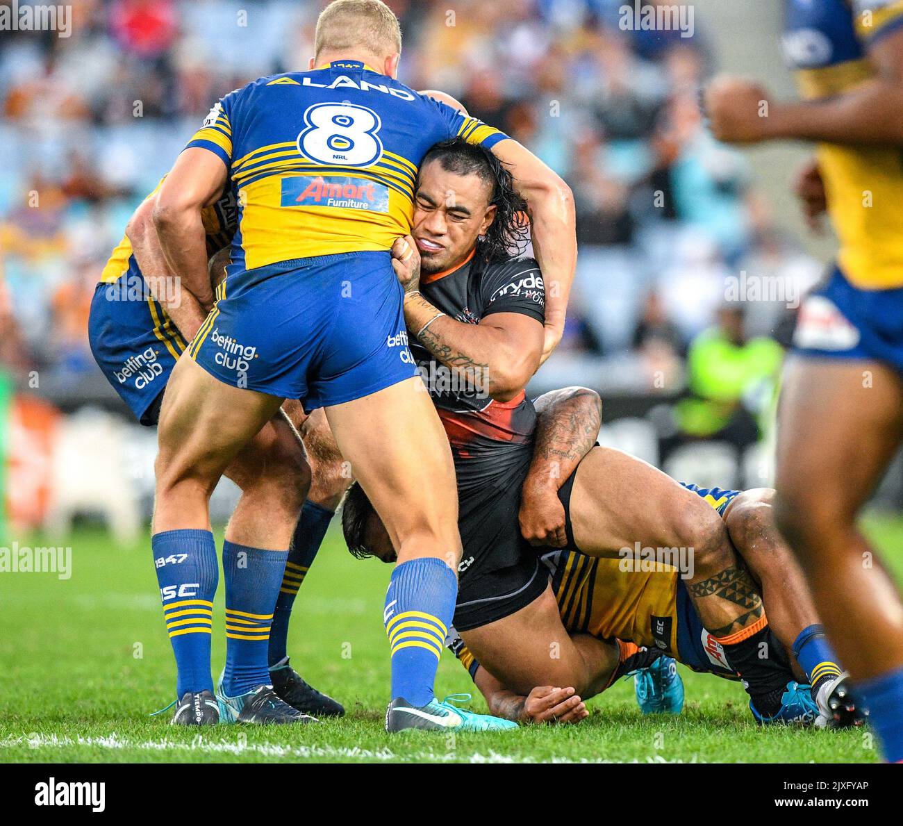 Mahe Fonua (right) of the Tigers is tackled by Daniel Alvaro of the ...