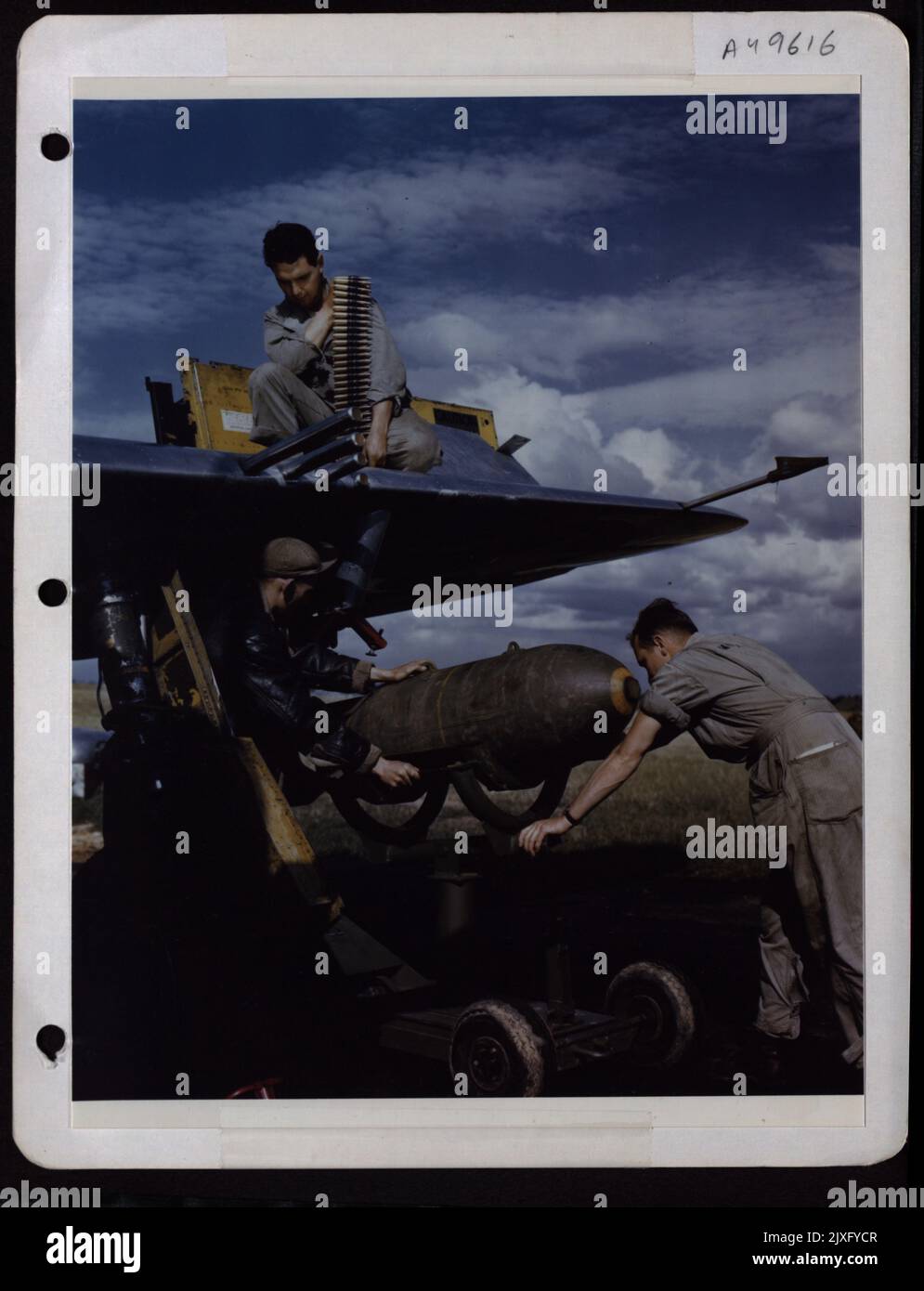 Ordnance Men Push Bomb Under Plane'S Wing And Load Ammunition In The 50 ...