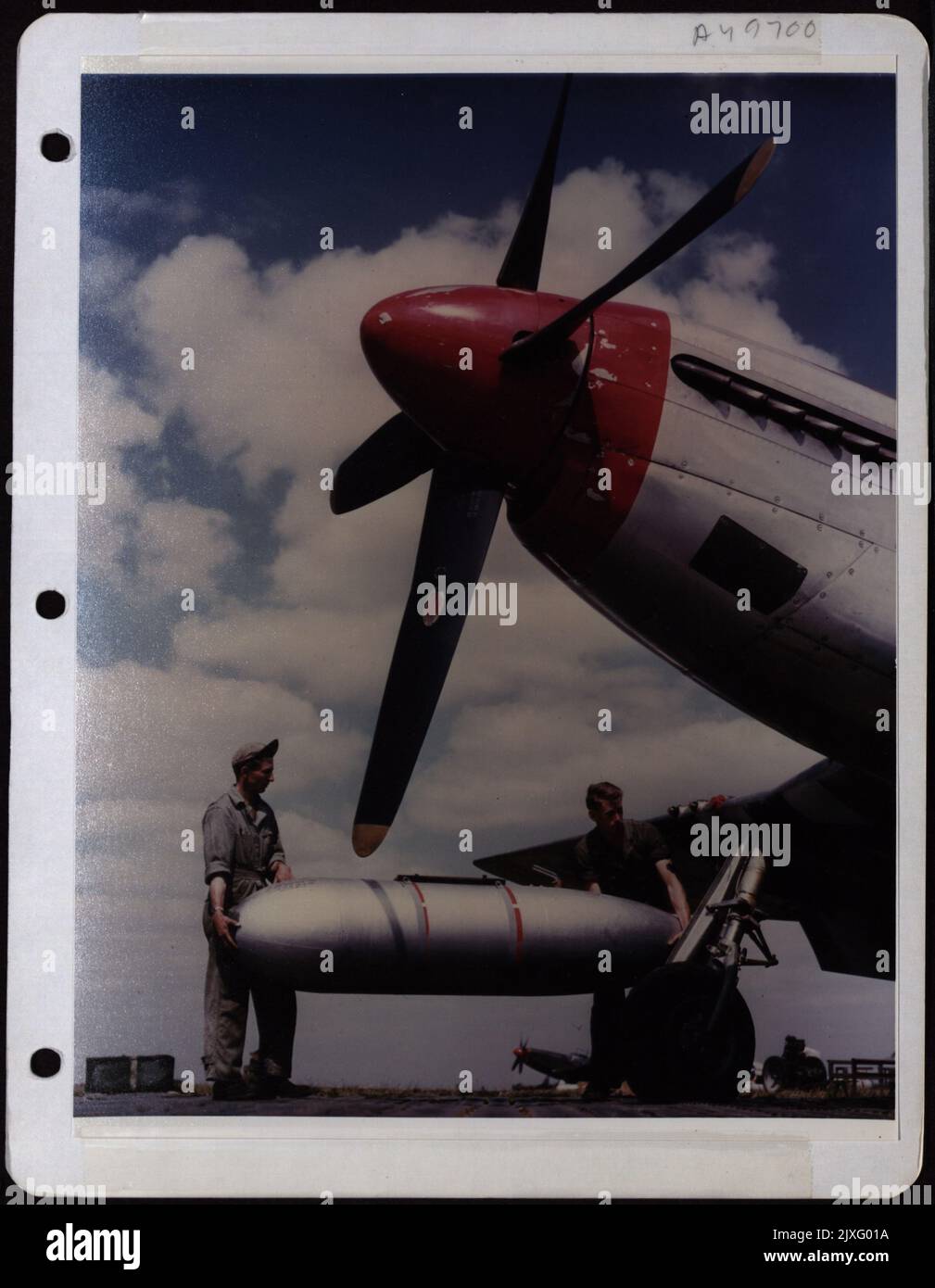 Crew Chiefs Placing Auxiliary Fuel Tank Under Wing Of A P-51 Stock ...