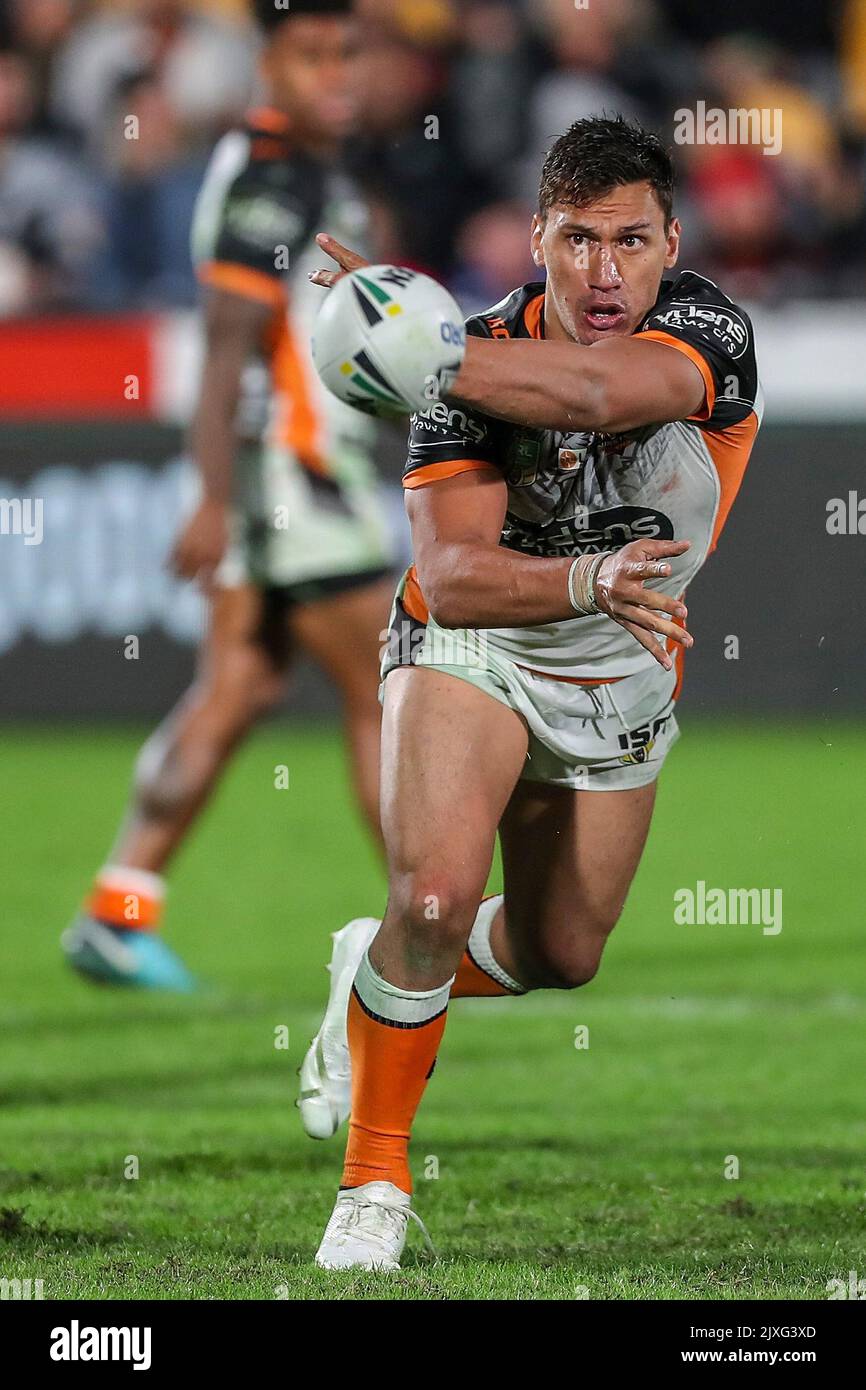 Elijah Taylor of the Tigers passes the ball during the Round 9 NRL ...