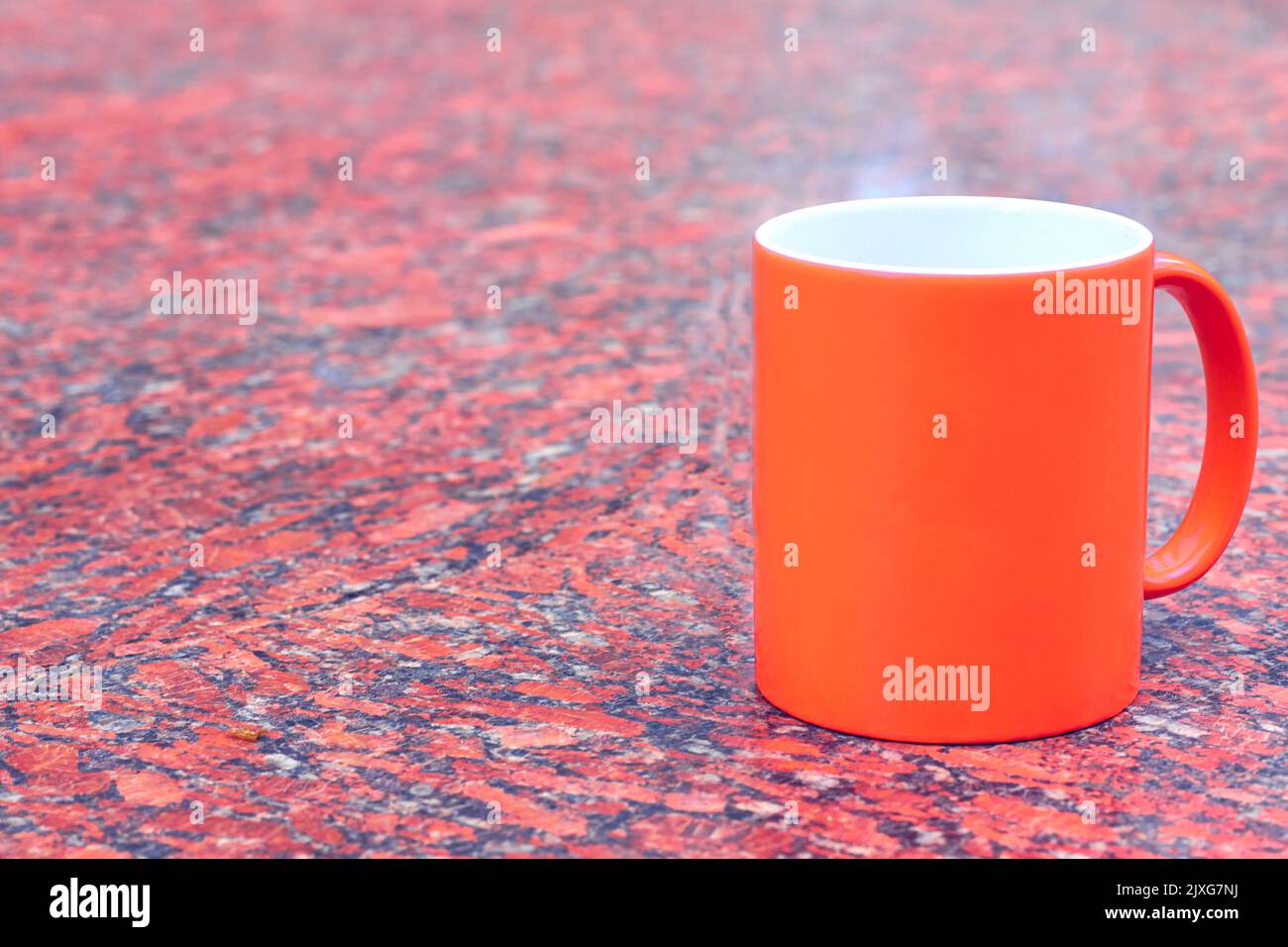 Red ceramic cup mug on bright red blue spotted background Stock Photo ...