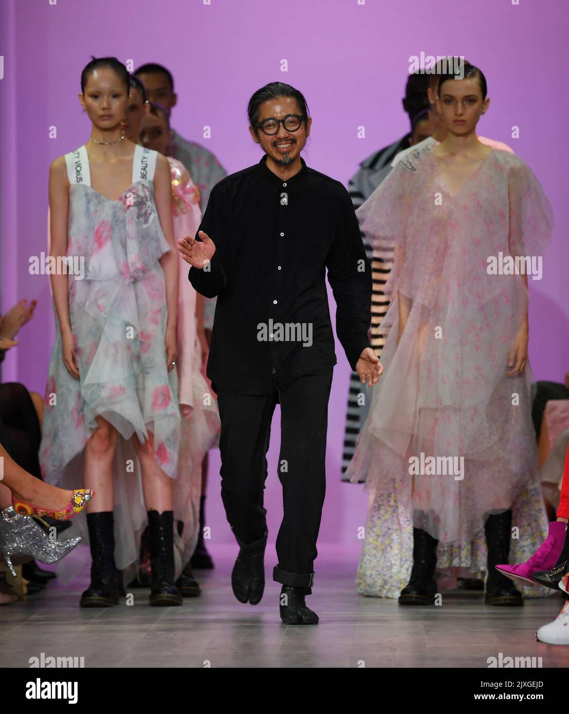 Fashio designer Akira Isogawa walks on stage after his Akira fashion ...