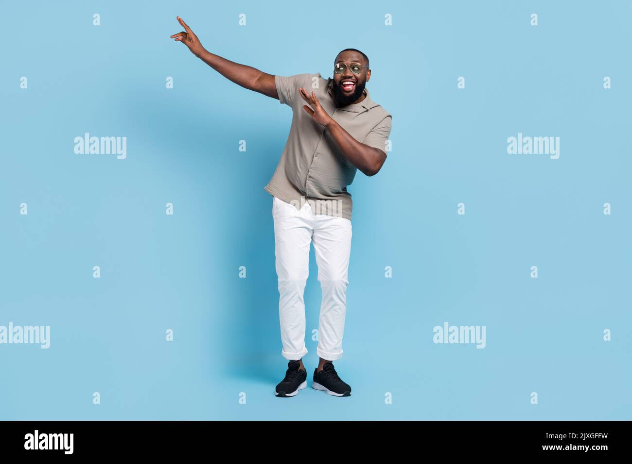 Full size photo of overjoyed cheerful man enjoy free time dancing ...