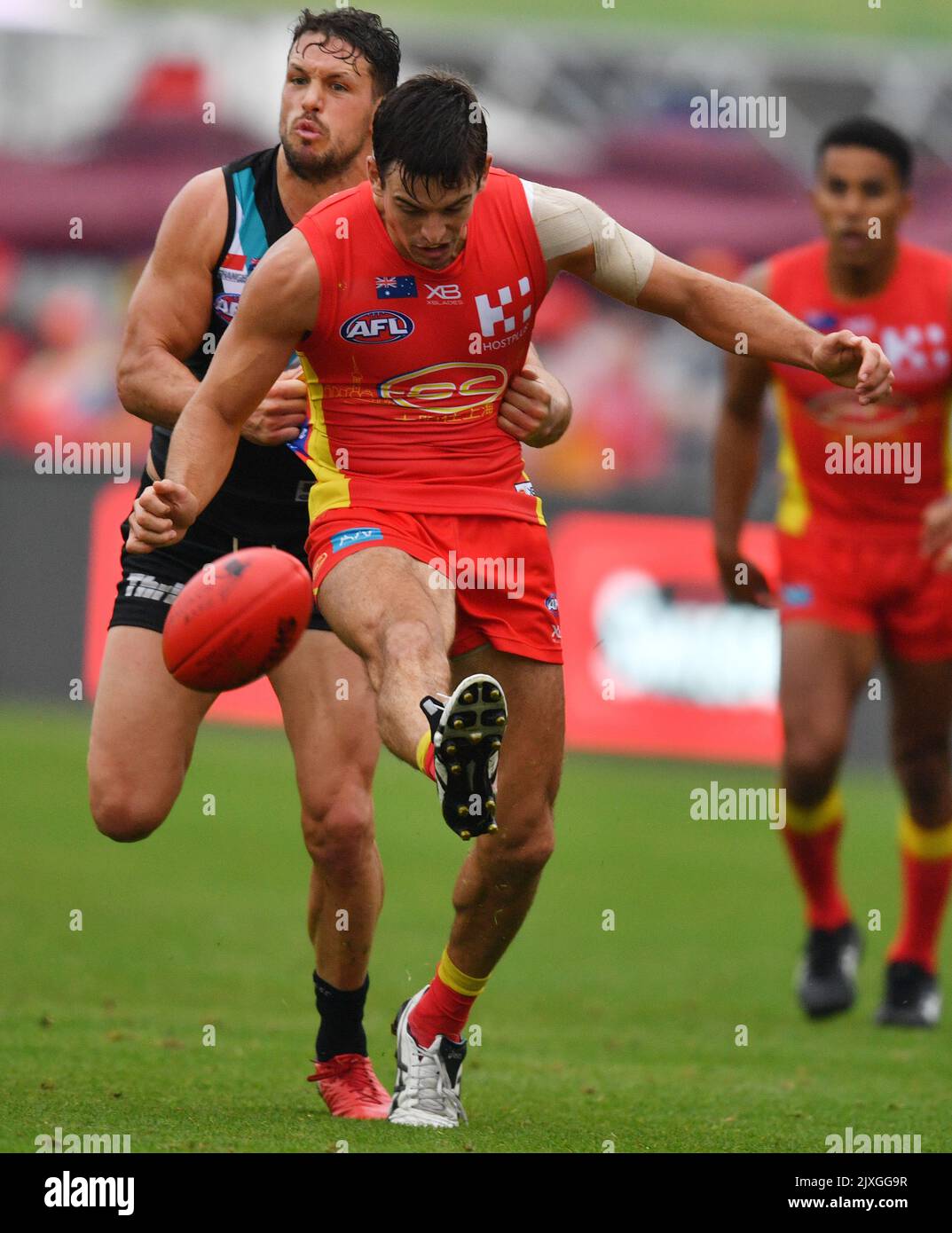 Jarryd Lyons of the Suns and Travis Boak of the Power during the Round ...