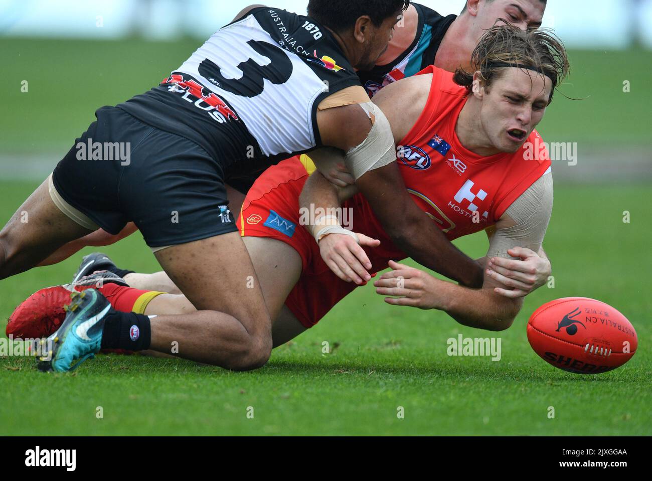 Jake Neade of the Power tackles Brad Scheer of the Suns during the ...