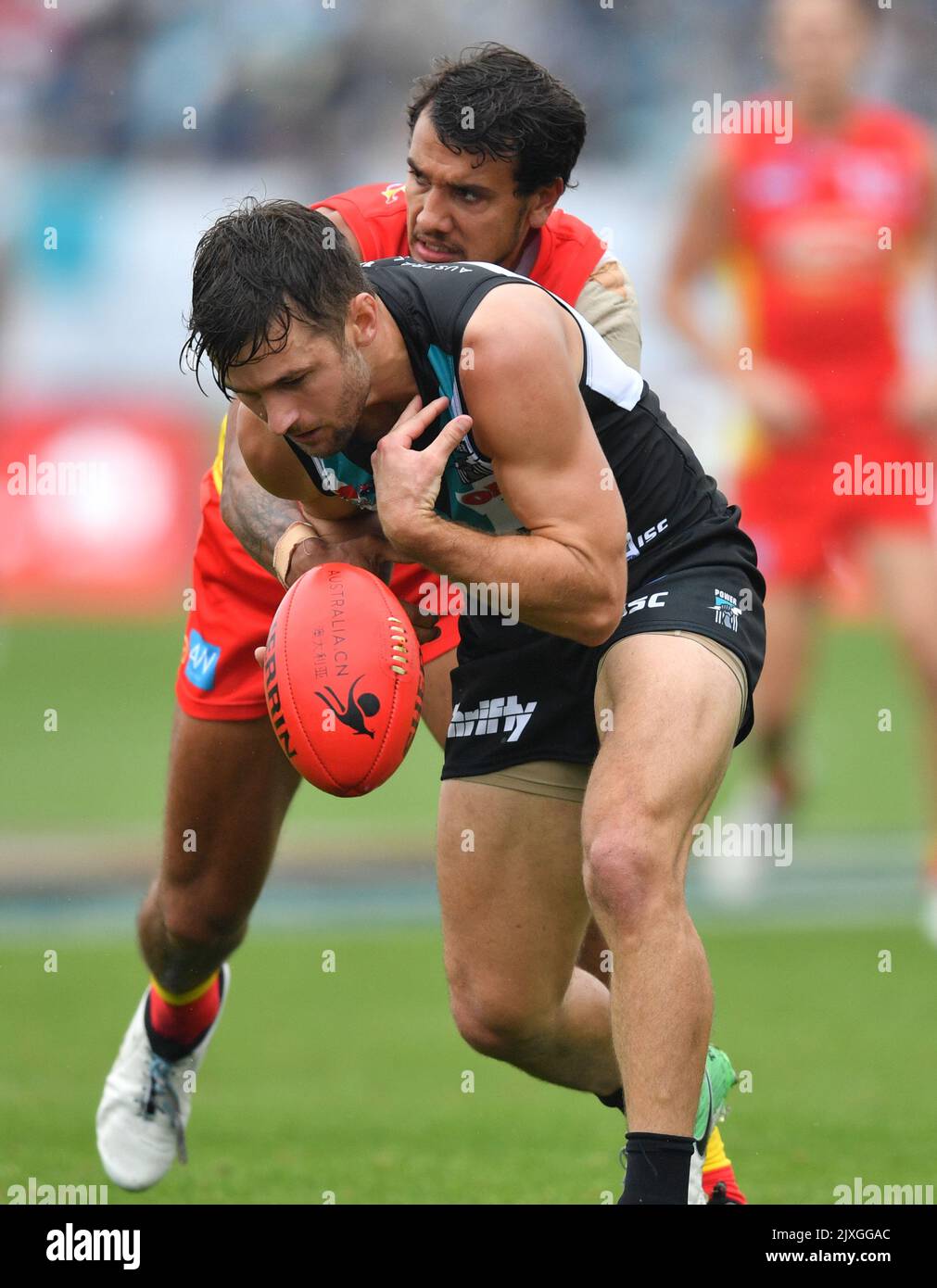Sam Gray of the Power and Callum Ah Chee of the Suns during the Round 9 ...