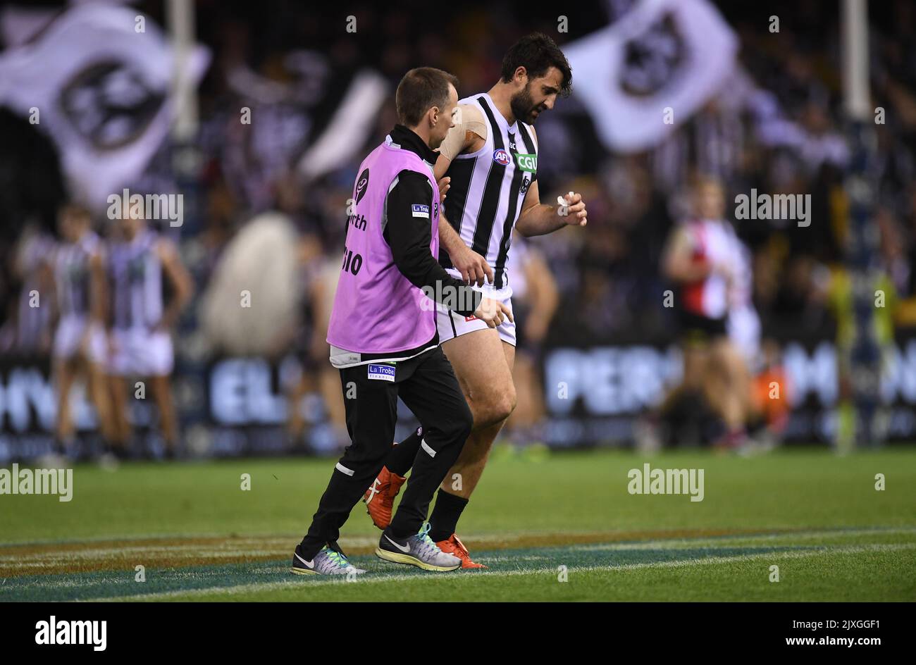 Alex Fasolo of the Magpies (right) makes his way from the field during ...