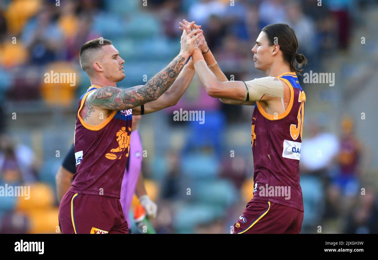 Eric Hipwood (right) of the Lions celebrates kicking a goal with Dayne ...
