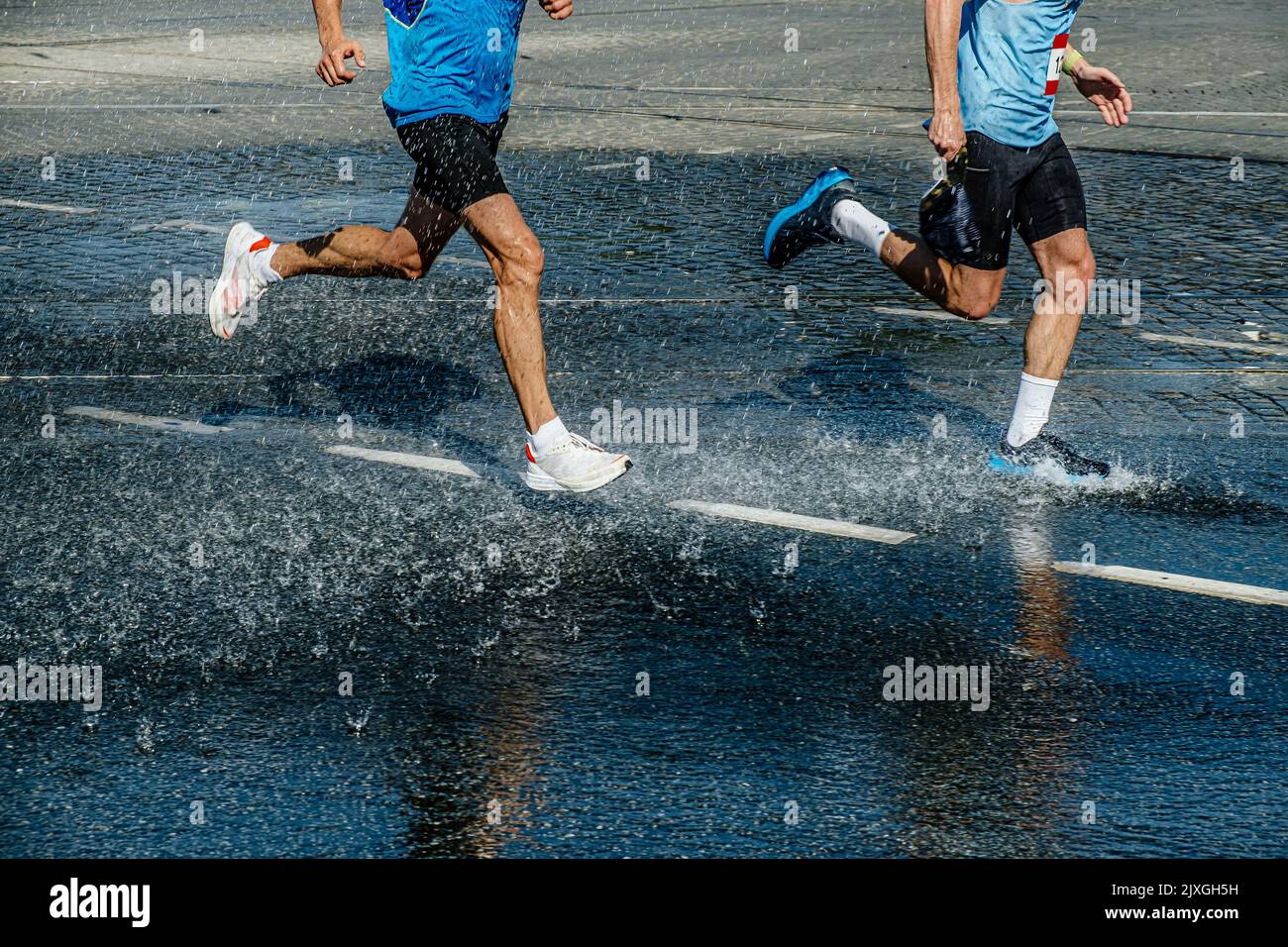 two runners running water station in hot weather Stock Photo - Alamy