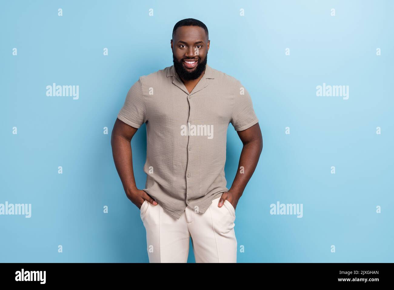 Photo of satisfied friendly young person put hands pockets toothy smile ...