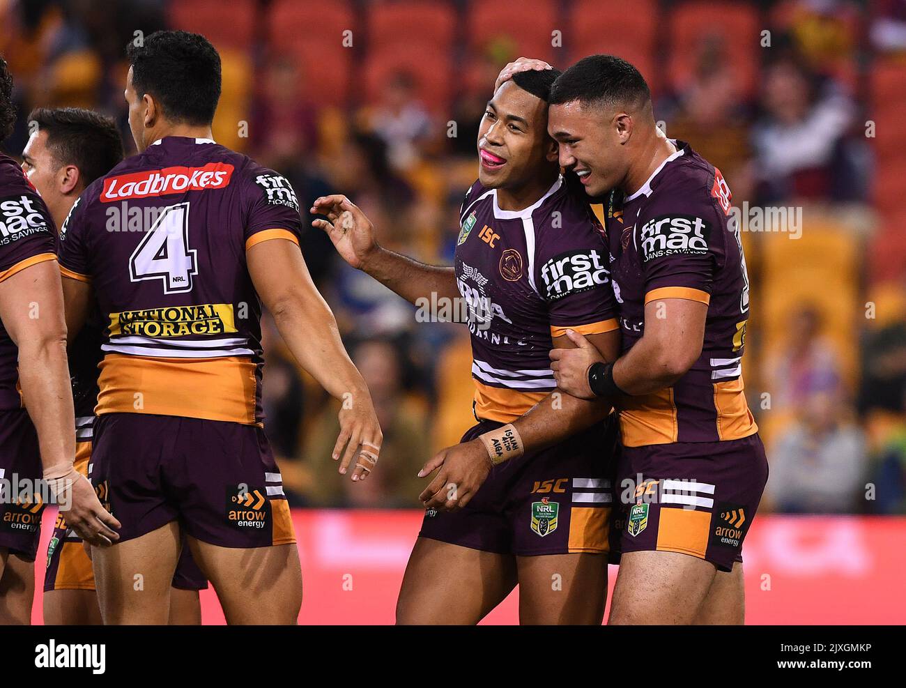 Jamayne Isaako of the Broncos (centre) reacts after scoring a try ...
