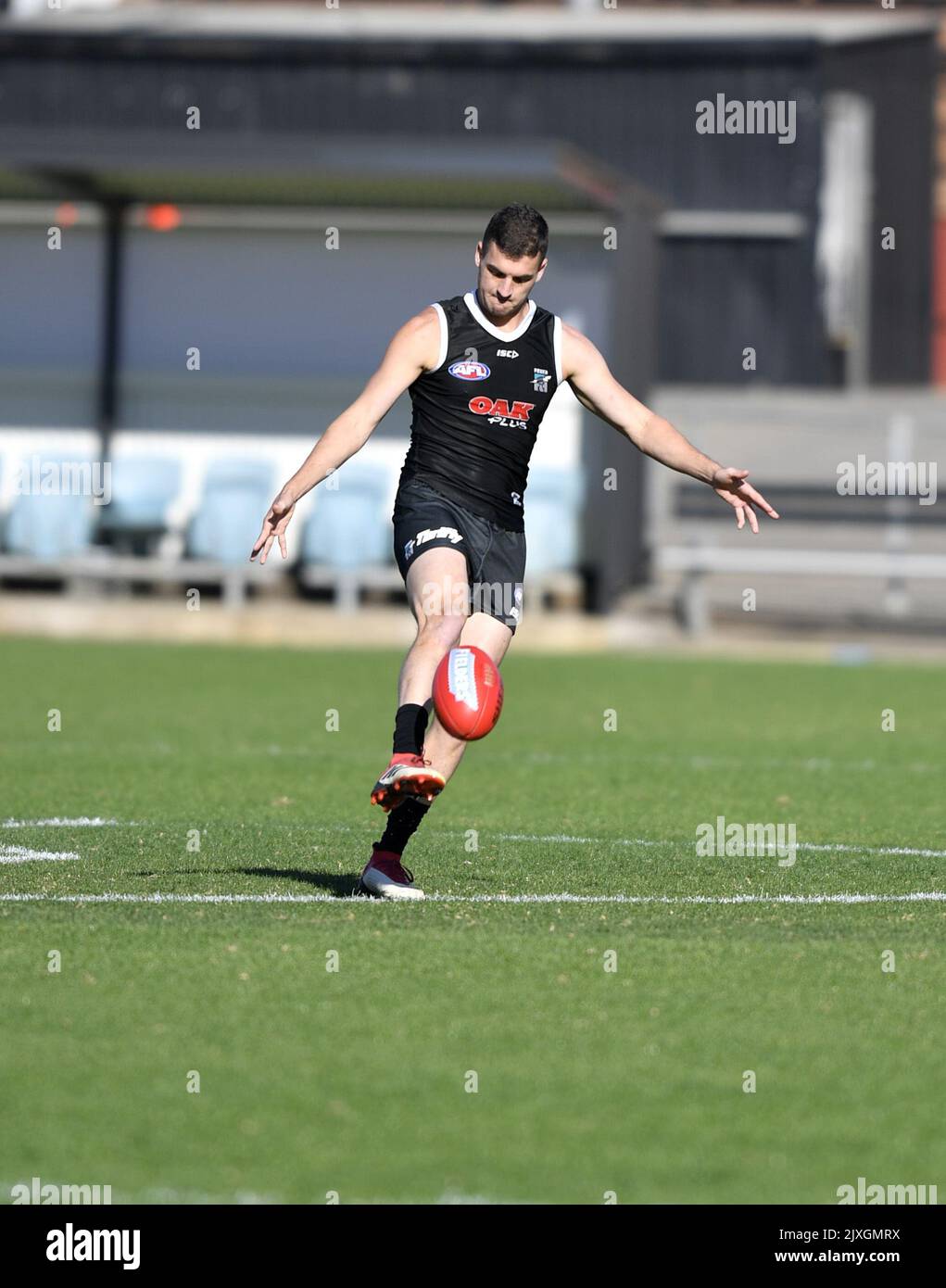 Port Adelaide Power player Tom Rockcliff kicks the ball during a team ...