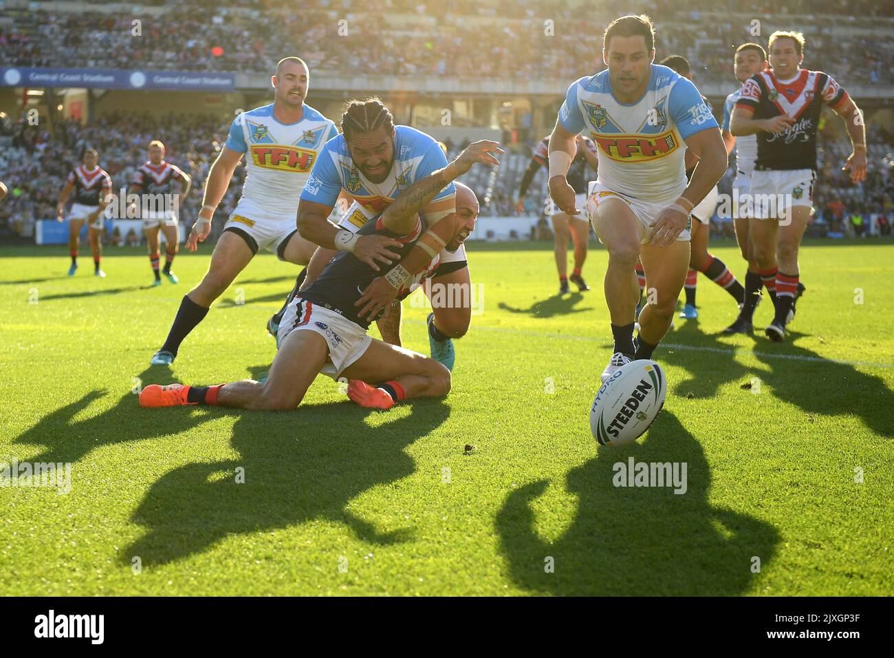 Michael Gordon of the Titans (right) scores a try during the Round 12 ...