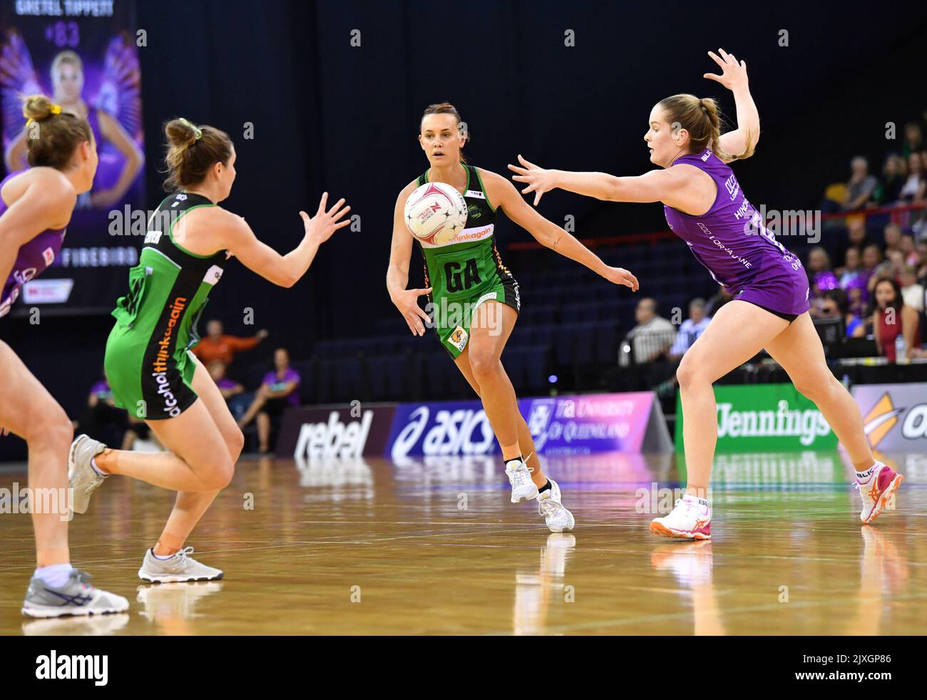 Natalie Medhurst (centre) of the Fever passes the ball to Ingrid Colyer ...