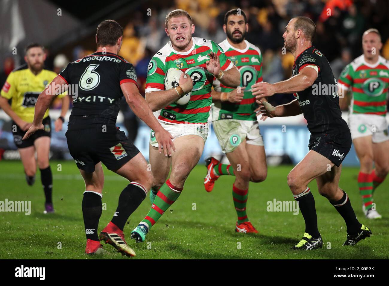 Thomas Burgess of the Rabbitohs (centre) is tackled by Simon Mannering ...