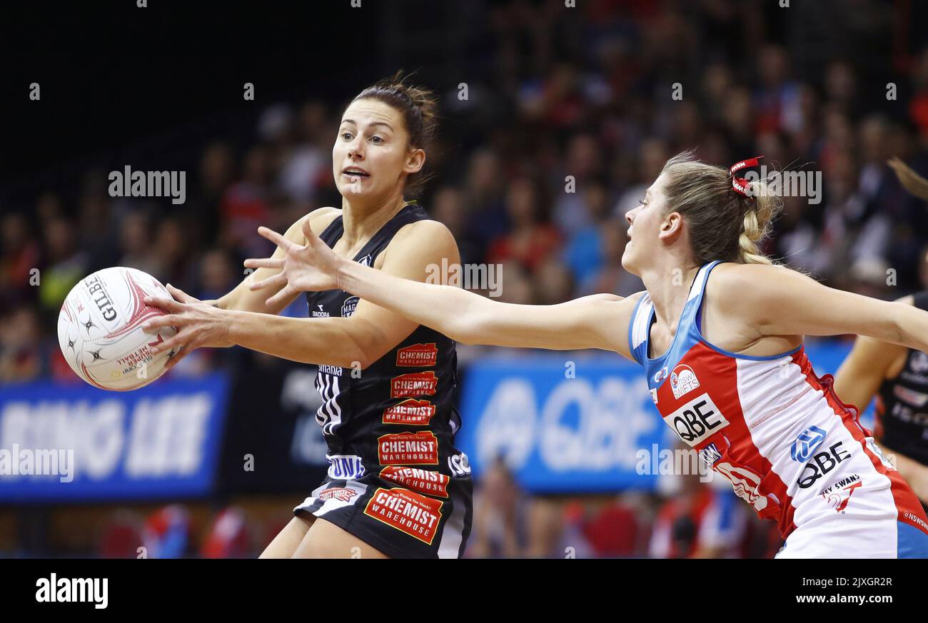 Madi Robinson of the Magpies catches the ball under the pressure of ...